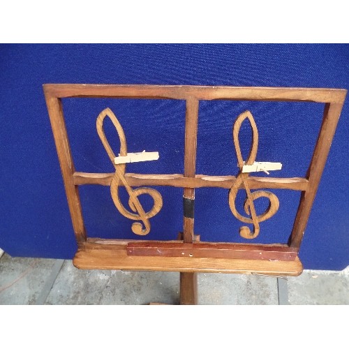 A VINTAGE WOODEN FRETWORK MUSIC STAND WITH TREBLE CLEF DESIGN
