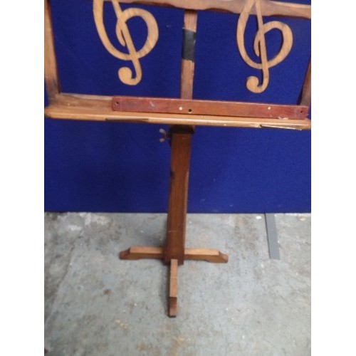 A VINTAGE WOODEN FRETWORK MUSIC STAND WITH TREBLE CLEF DESIGN