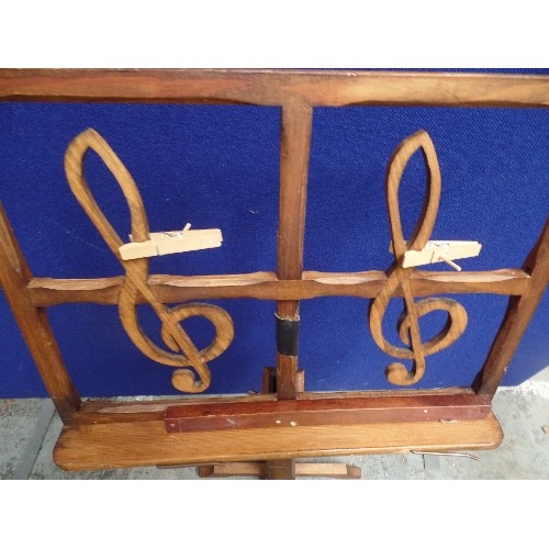 A VINTAGE WOODEN FRETWORK MUSIC STAND WITH TREBLE CLEF DESIGN