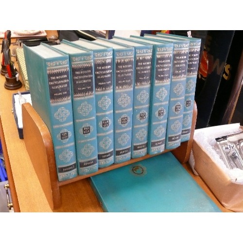 THE MODERN ENCYCLOPEDIA AND ATLAS IN GREEN, ON A SMALL SHELF.