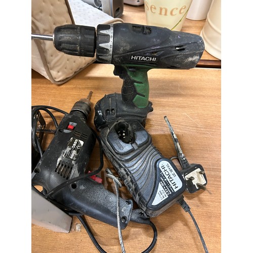AN ELECTRIC DRILL, STAPLER, JIGSAW AND A BATTERY DRILL
