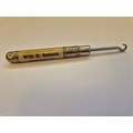 Small advertising pocket button hook. White metal tube with screw ...