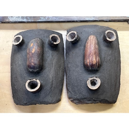 A pair of African wall masks with projecting eyes, noses and mouths by ...