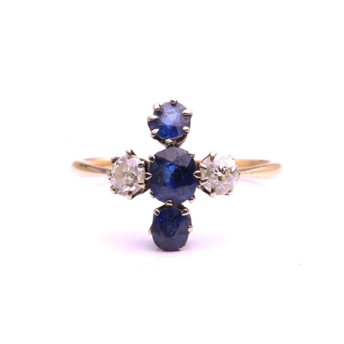 A diamond and sapphire cross ring claw set with three round mixed cut ...
