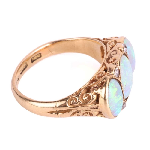 An opal and diamond-set three stone ring, the oval cabochon opals are ...