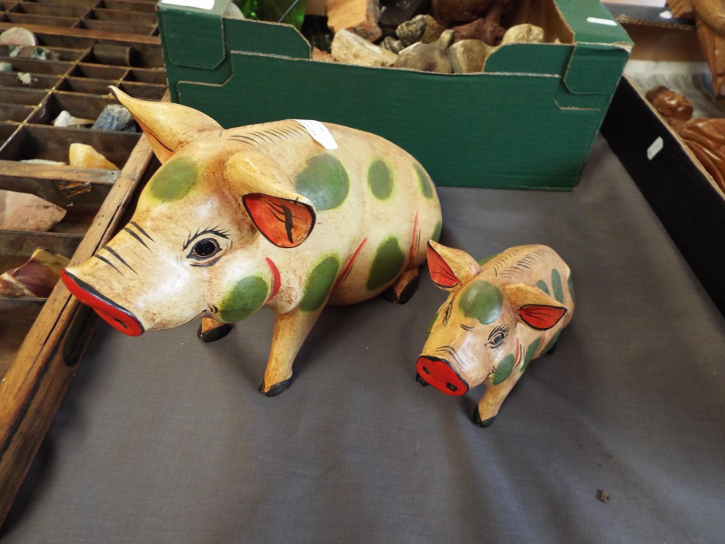 Two carved wooden hand-painted Pigs