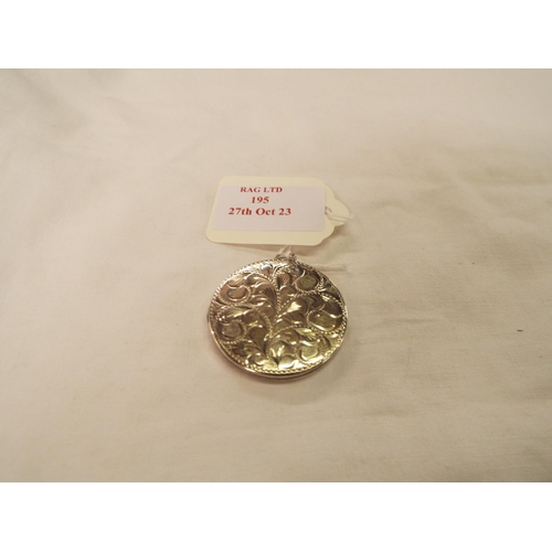 A silver pendant having engine turned decoration