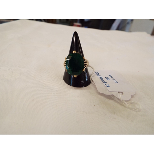 An 18ct gold ring inset with large oval emerald, size S