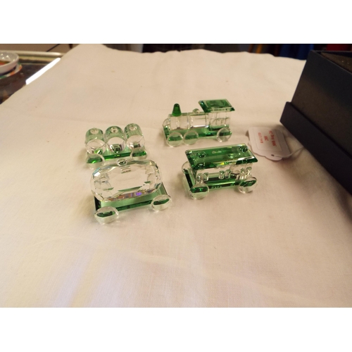 A boxed four piece Zaydner Crystal green and clear train set