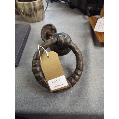 An antique iron ring shaped door knocker