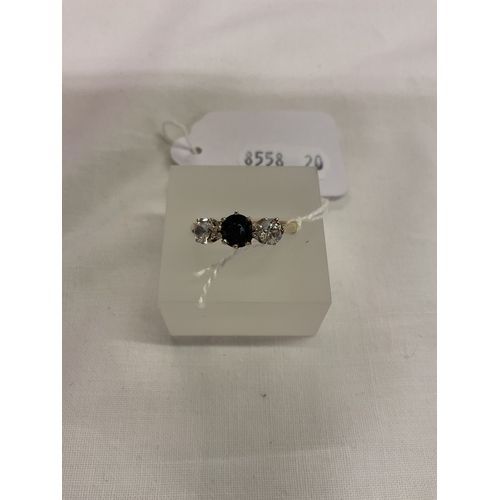 A 9ct gold ring inset with central blue sapphire flanked by clear ...