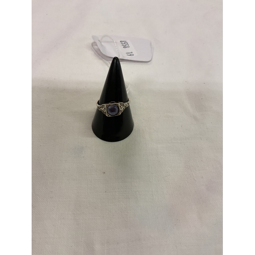 A 9ct gold and platinum ring inset with natural sapphire the raised ...