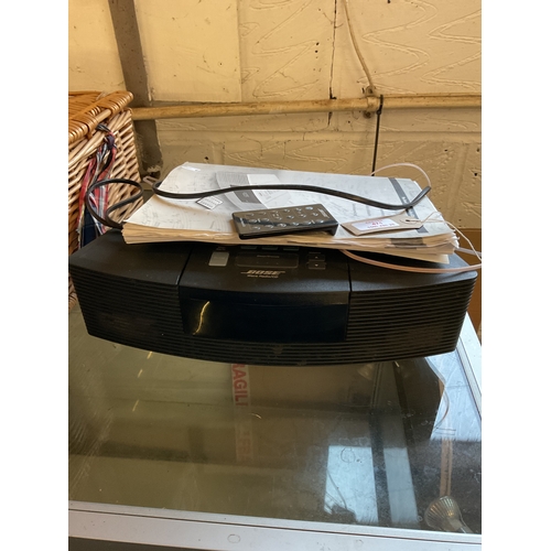A Bose 'Wave' radio with remotes and booklets