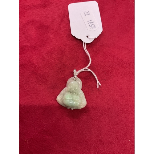 A large carved jade having diamond set pendant loop