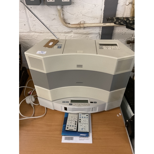 A Bose acoustic Wave music system with remote controls