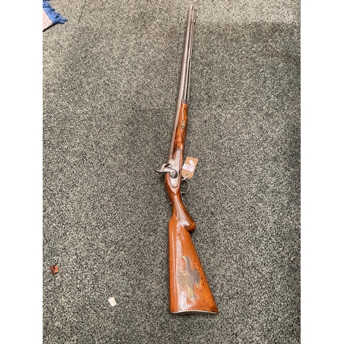A reproduction single barrel flintlock rifle
