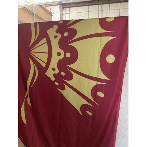 A large burgundy flag with Gola Crown