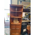 An Ercol large corner unit having two shelves above a cupboard