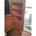 An Ercol large corner unit having two shelves above a cupboard
