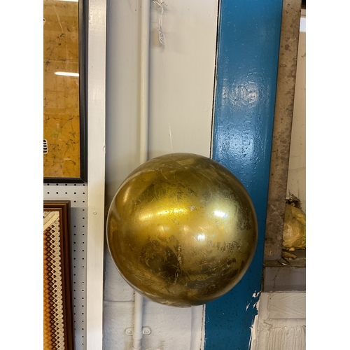 A gold painted shop display bauble
