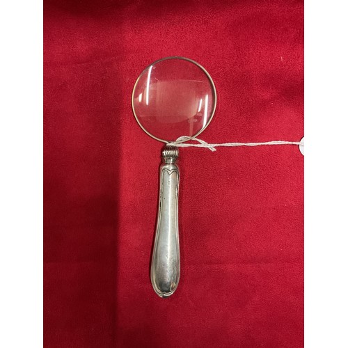 A silver handled magnifying glass