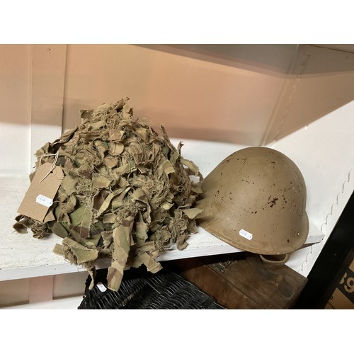 Two film prop army helmets