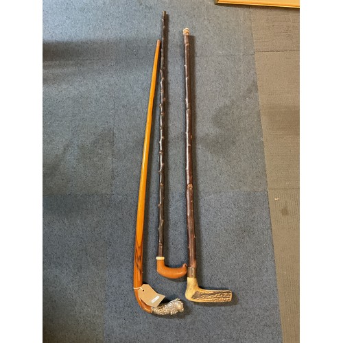 Three vintage walking canes, one having ornate white metal handle