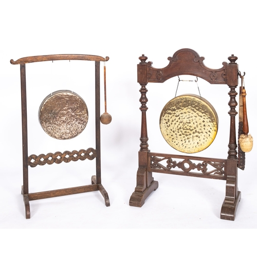 Two Victorian oak mounted brass dinner gongs, late 19th century; the ...