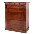 A Victorian mahogany Wellington Chest, the overhanging frieze with ...