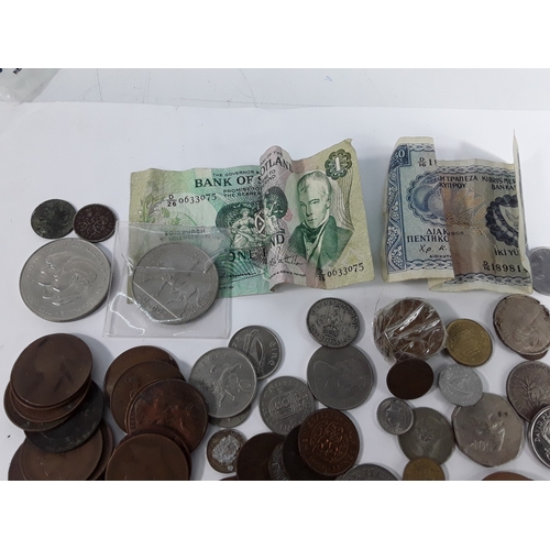Tin of various coins and banknotes