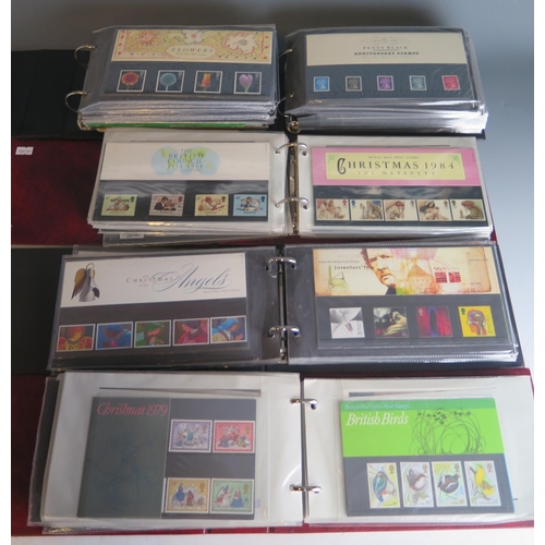 A collection of first day covers, postcards and stamp sets contained in ...