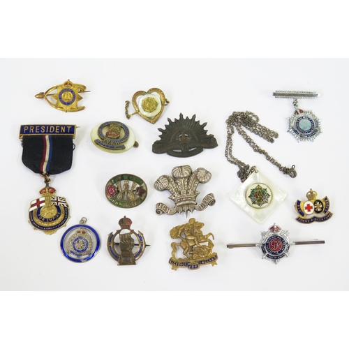A small collection of army cap badges, lapel badges etc