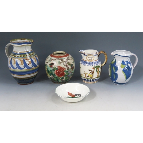 A reproduction pottery moulded jug with Bovey 1800 within a wreath ...