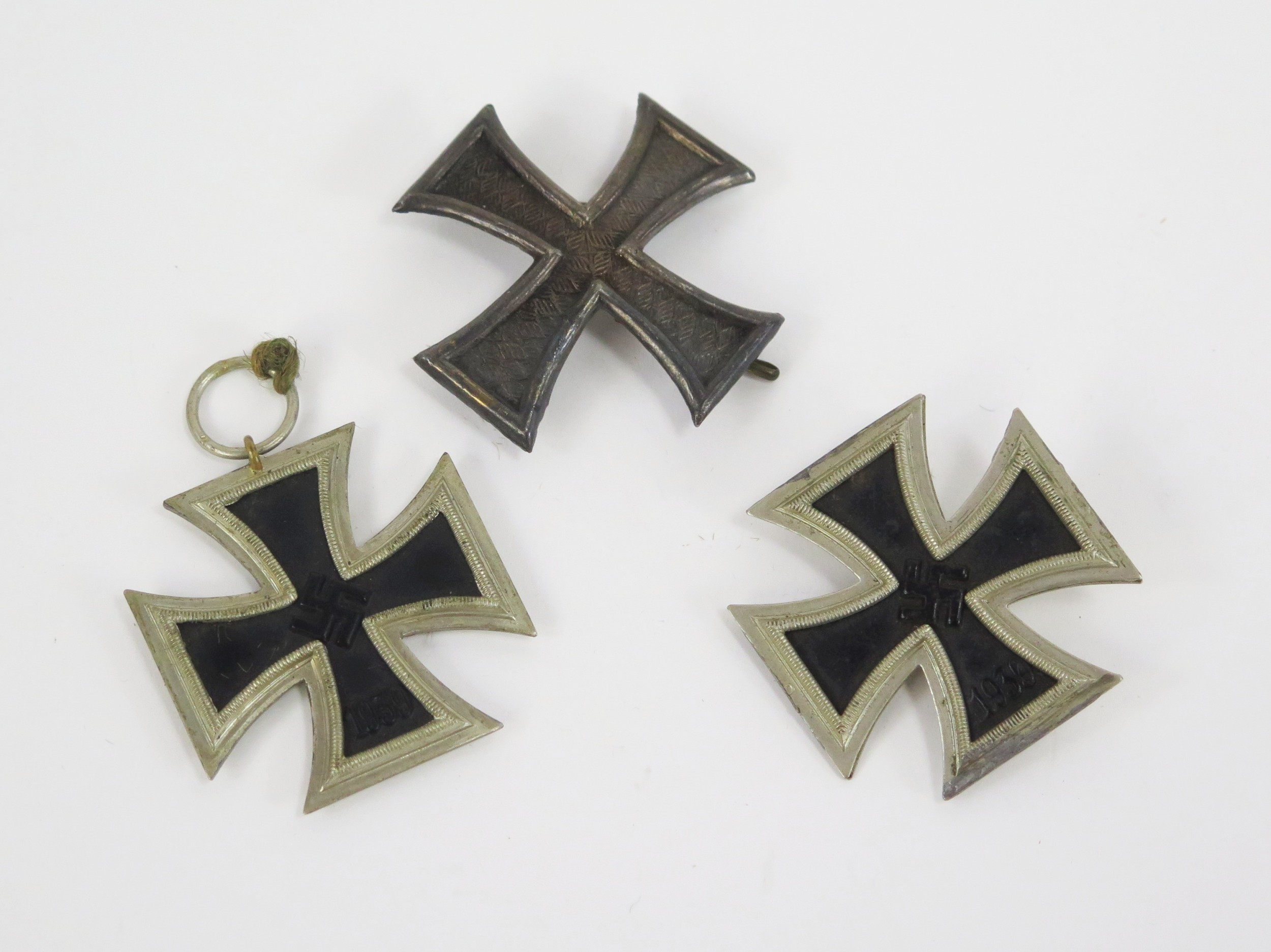 A WWII period German iron cross 1st class together with an iron cross ...