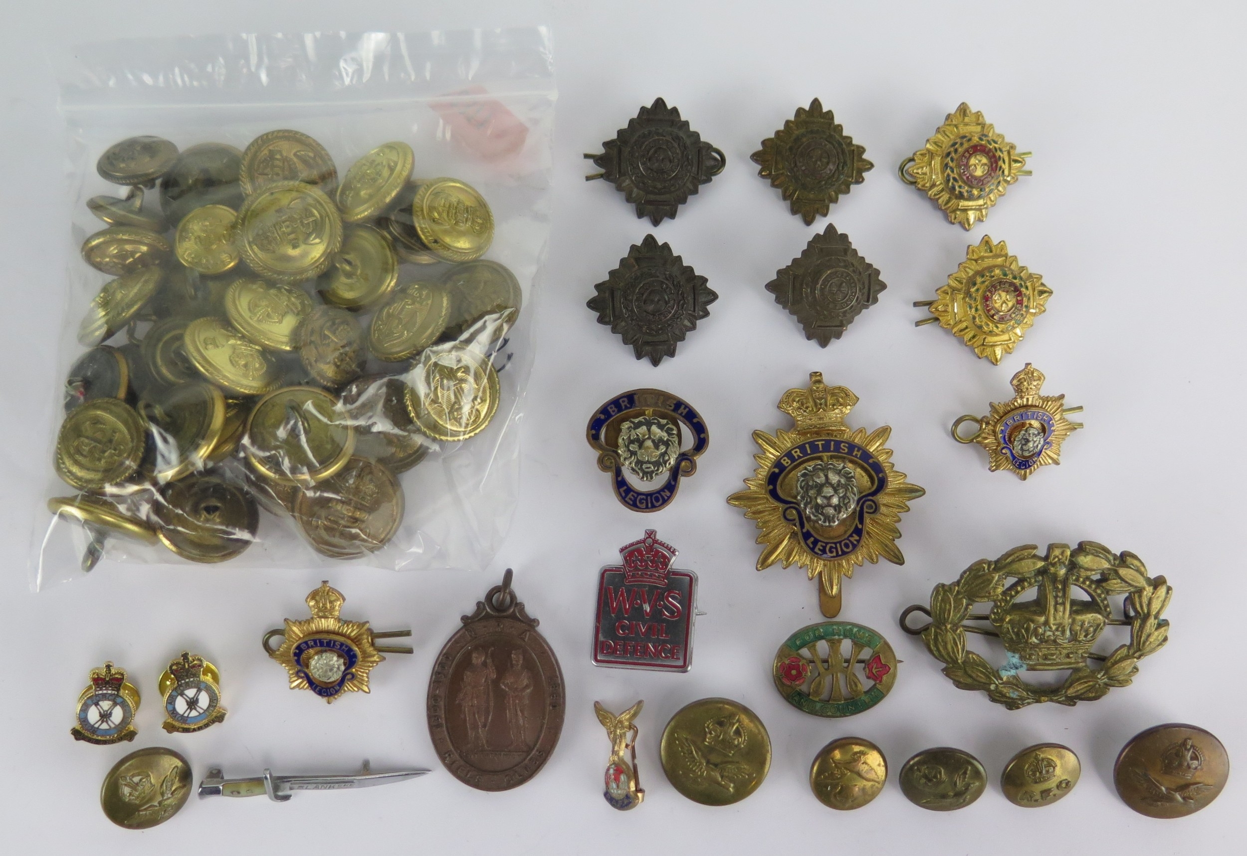 A collection of Navy buttons, RAF buttons, Army cap badges, etc.