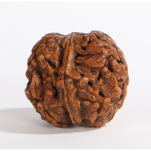 CHINESE CARVED WALNUT SHELL, QING DYNASTY. Carved in relief with ...