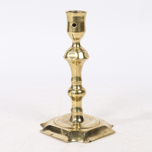 A GEORGE I BRASS CANDLESTICK, CIRCA 1720. having a plain socket above a ...