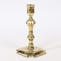 A GEORGE I BRASS CANDLESTICK, CIRCA 1720. having a plain socket above a ...