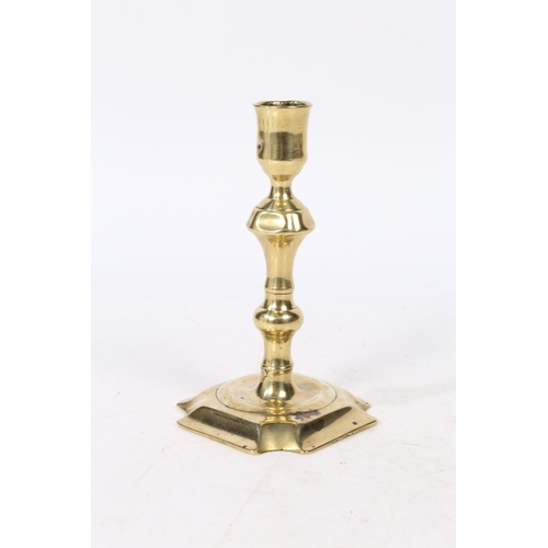 A GEORGE I BRASS CANDLESTICK, CIRCA 1720. having a plain socket above a ...