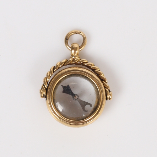 ANTIQUE 18CT GOLD SPINNING COMPASS FOB. A solid chain C-shaped frame ...