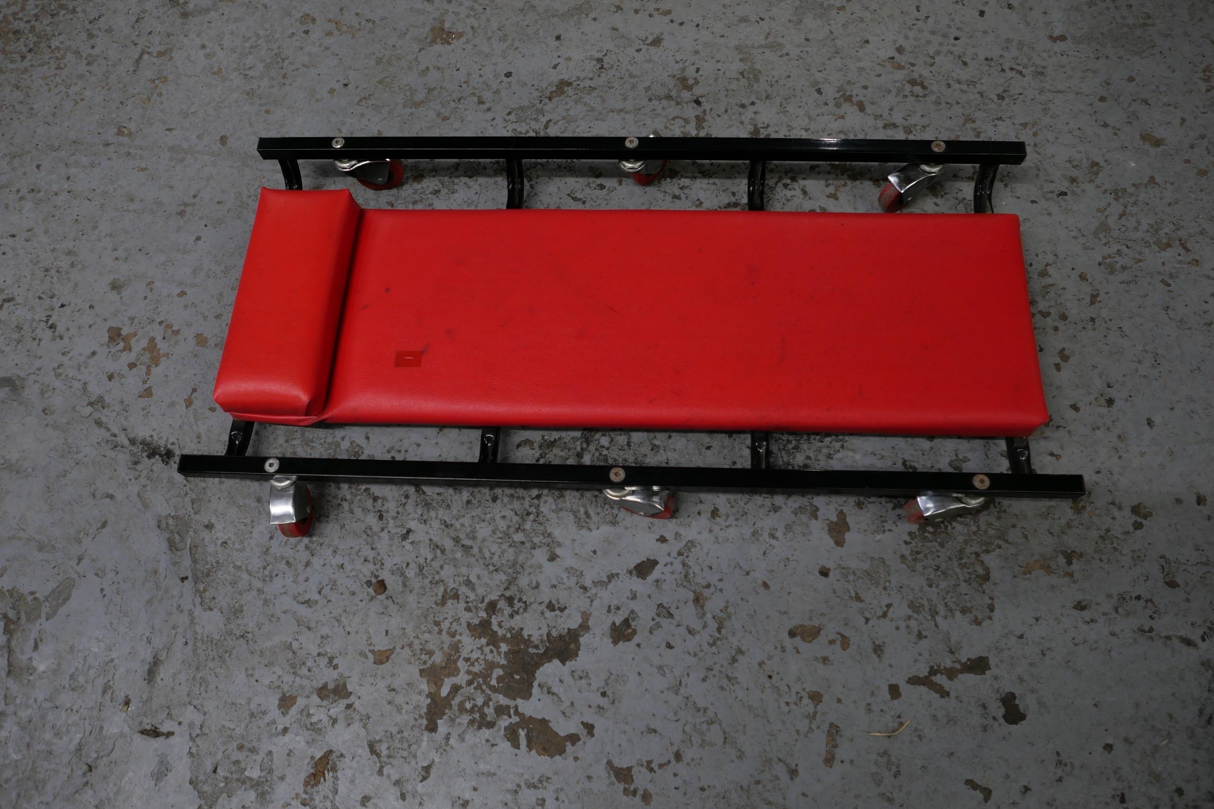 A six wheeled and padded mechanic's crawler board