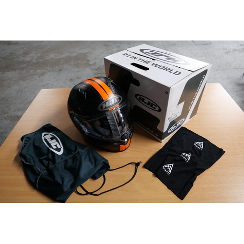 An HJC motorcyclist's full face helmet, complete with neck warmer, bag ...