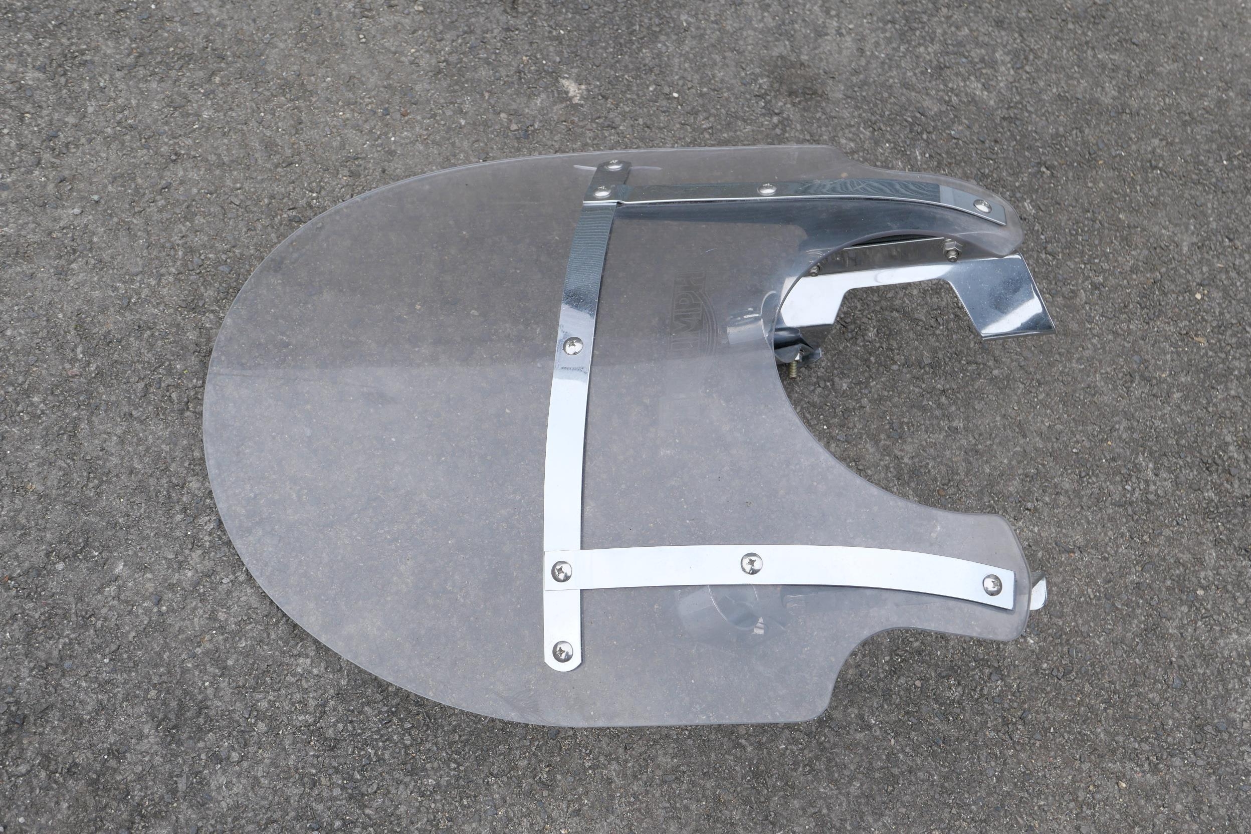 A modern Triumph Bonneville windscreen, complete with mounting brackets ...