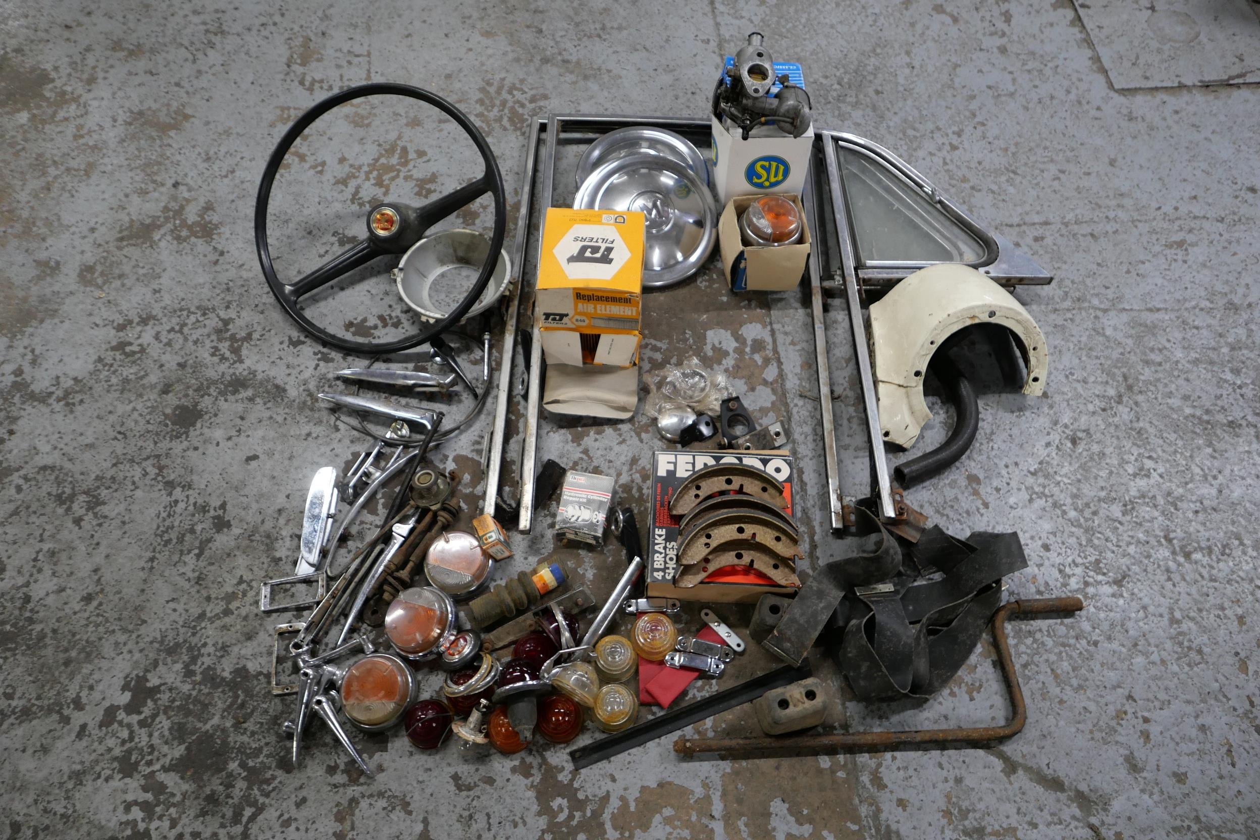 A quantity of Morris Minor 1000 spare parts: front and rear lamp lenses ...