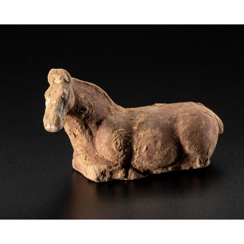 A CHINESE MINIATURE POTTERY FIGURE OF A RECUMBENT HORSE, TANG DYNASTY ...