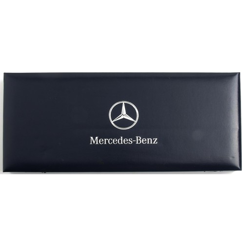 A BOXED SET OF SILVER COINS BY MERCEDES BENZ