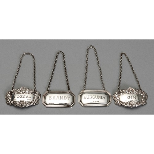 FOUR SILVER DECANTER LABELS, VARIOUS MAKERS AND DATES