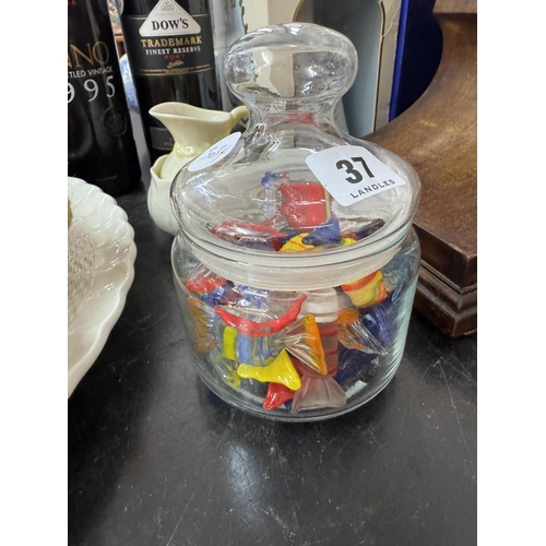 A jar of assorted coloured glass sweets