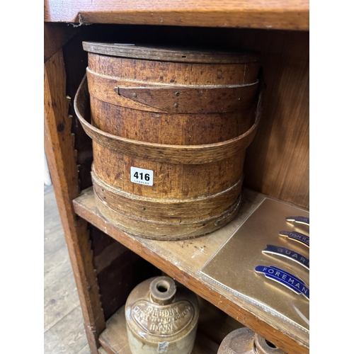 A wooden bound barrel with lid and handle
