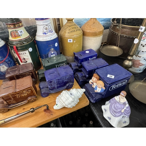 6 novelty money boxes and a Wade Tetley tea caddy, all as lorries